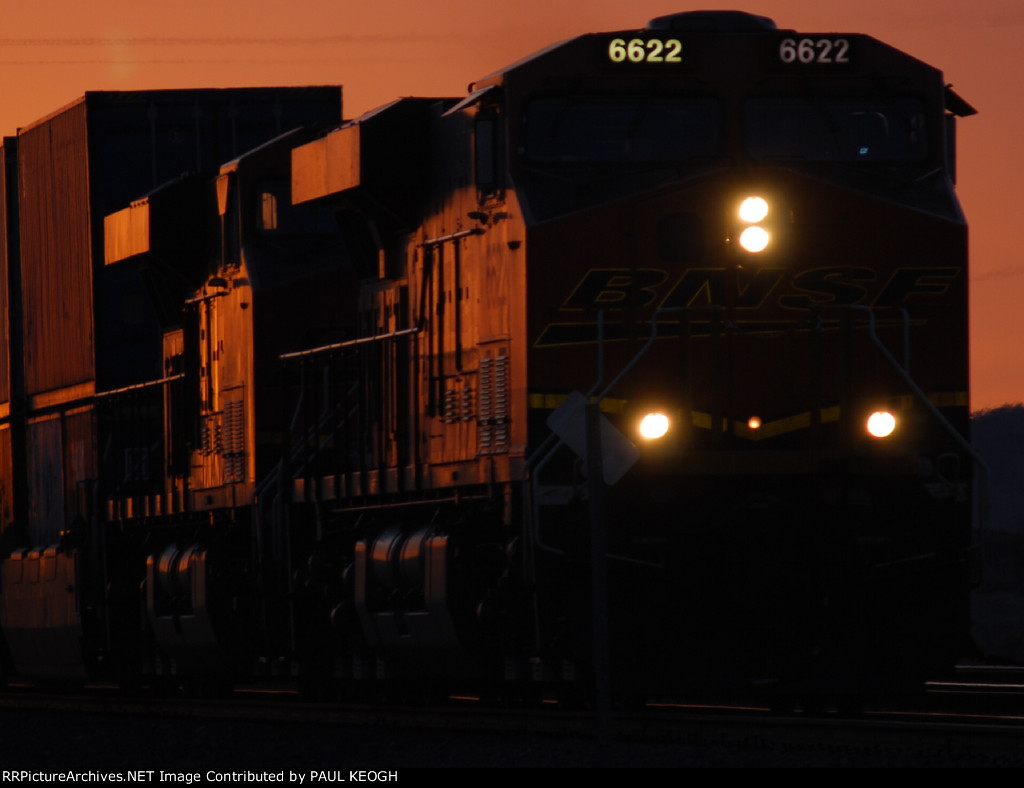 A Zoom in shot of BNSF 6622 as she comes out of a Brilliant California Dusk/Sunset as she leads ...